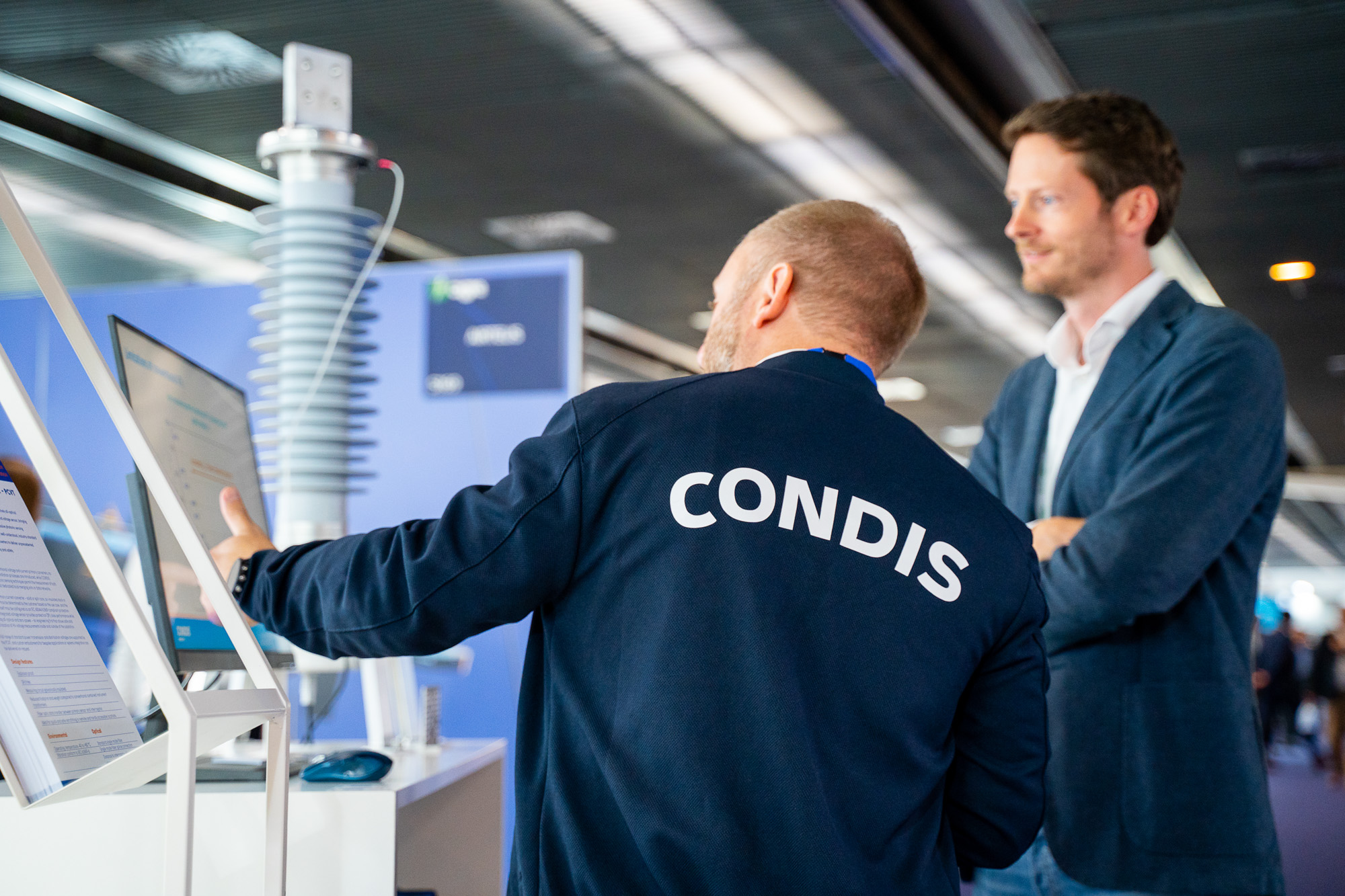 CONDIS Group at CIGRE - Thomas presents the CR divider to a visitor